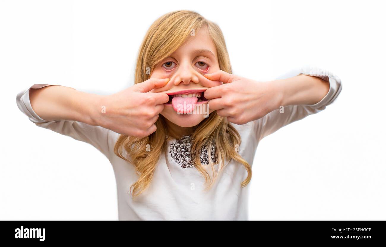 Blonde-haired girl expressing her creativity by making a silly face ...
