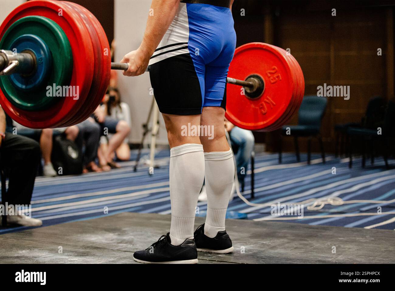 athlete powerlifter lifts heavy barbell during powerlifting competition ...