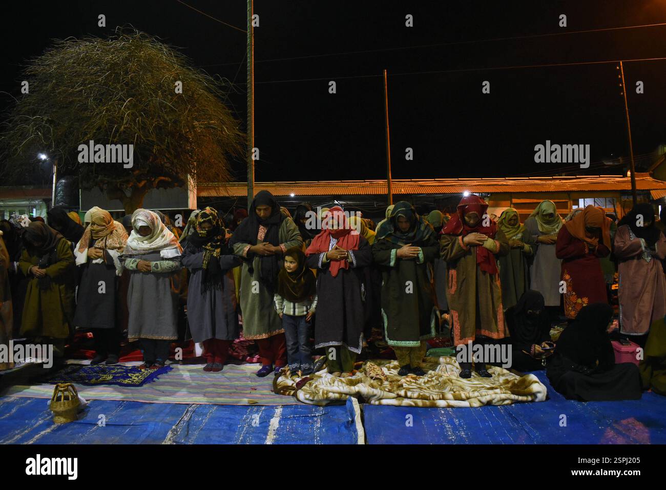 Srinagar, India. 13th Feb, 2025. Women offer Isha prayers at night ...