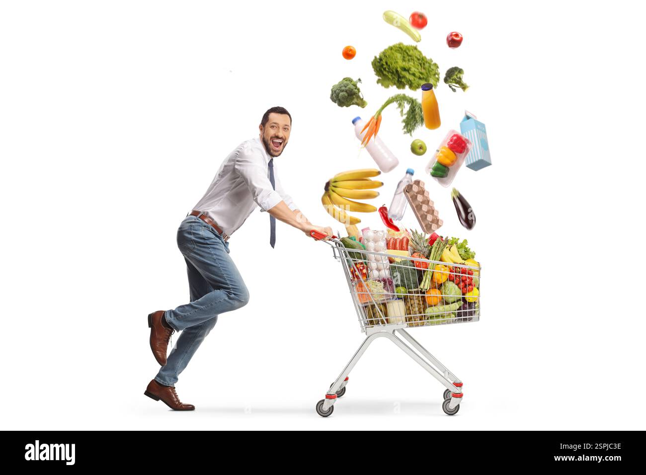 Excited man running withfalling groceries in a shopping cart and ...