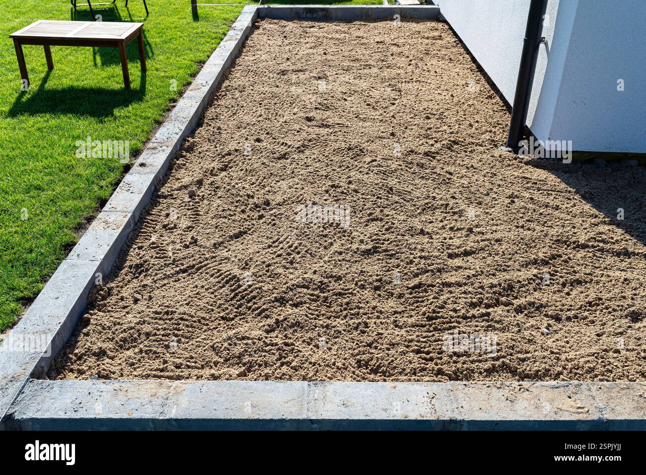Sand bed prepared for compaction for construction of the terrace ...