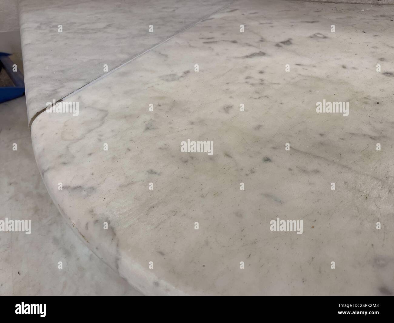 Close-up view of a section of off-white marble surface with subtle gray ...