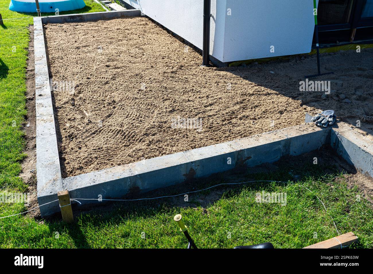 Sand bed prepared for compaction for construction of the terrace ...