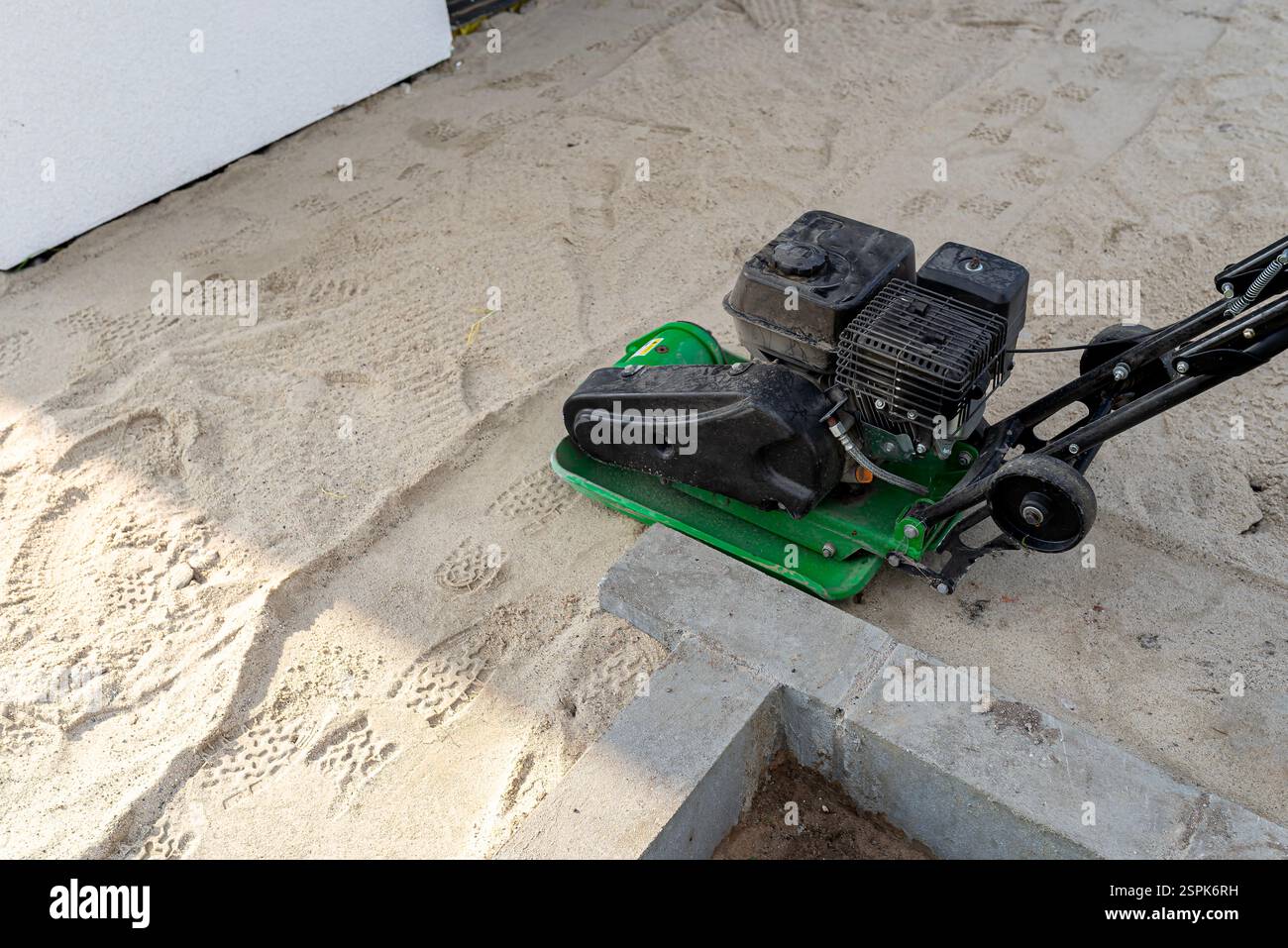 Compacted sand on a terrace under construction, using a gasoline ...