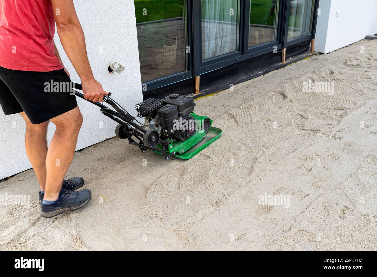 Compacted sand on a terrace under construction, using a gasoline ...