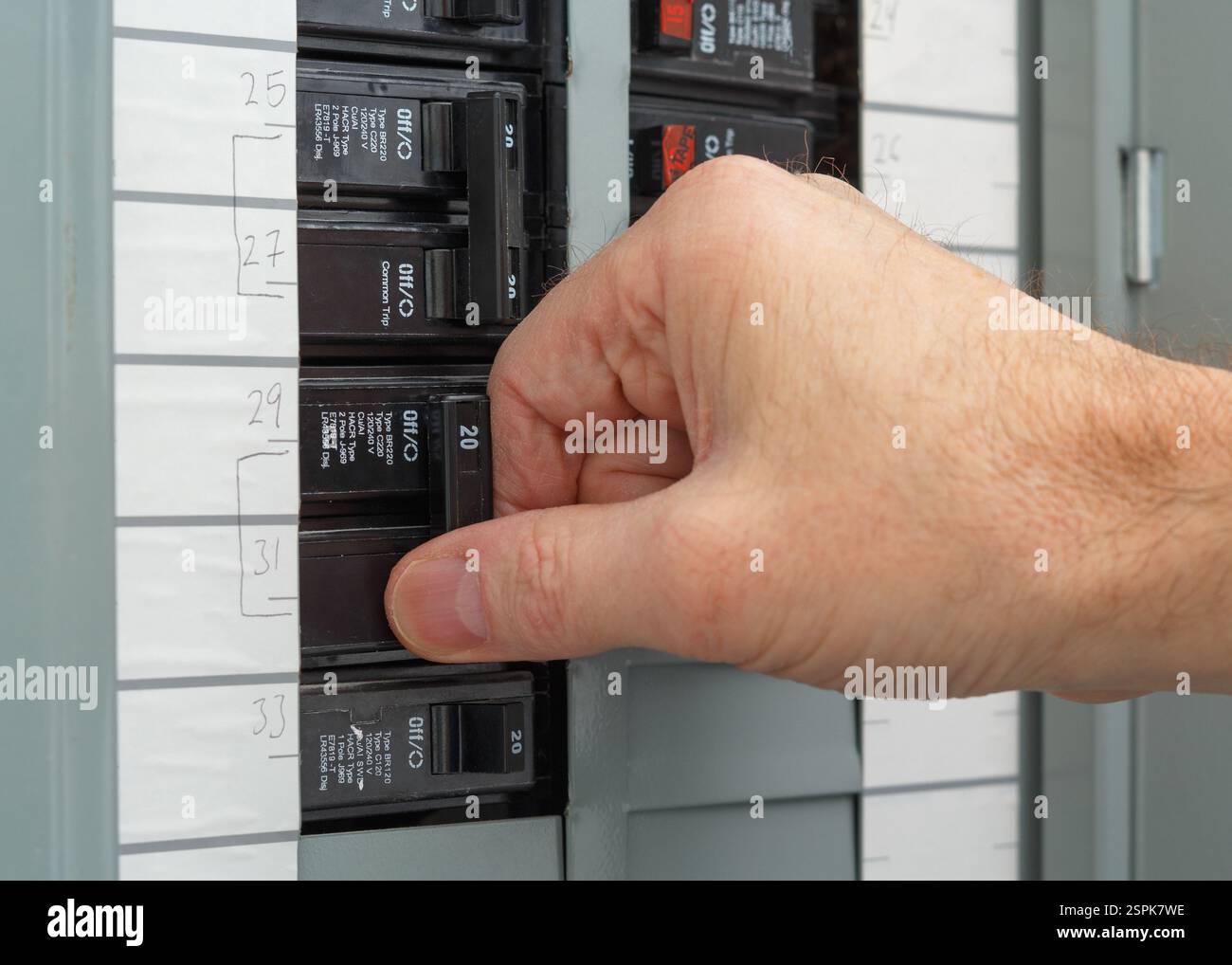 Male's hand turning off electrical circuit breaker Stock Photo - Alamy