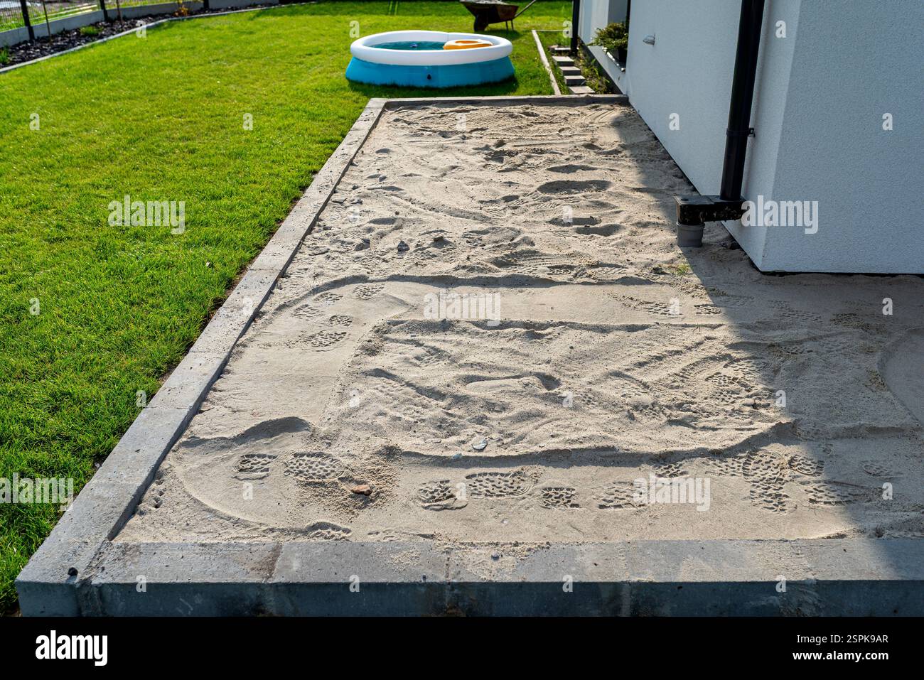 Compacted sand on a terrace under construction, using a gasoline ...