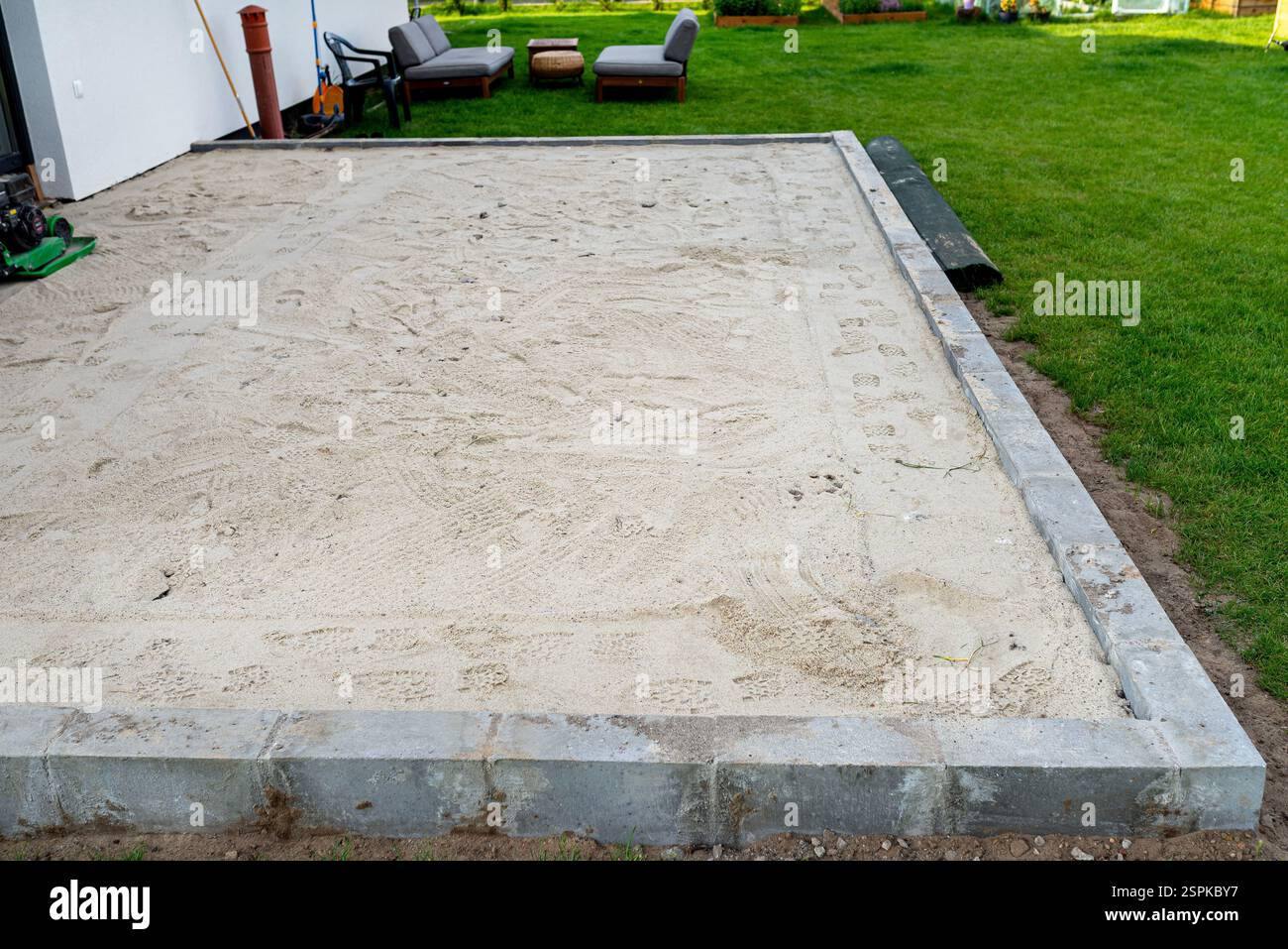 Compacted sand on a terrace under construction, using a gasoline ...