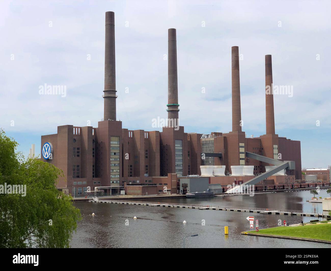 Large brick industrial building with four tall smokestacks, a prominent ...