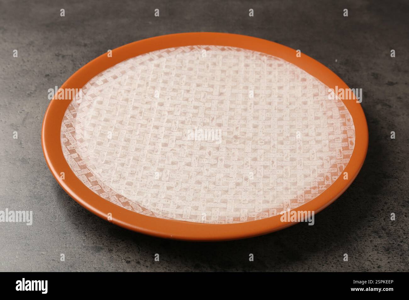Edible rice paper sheets on grey textured table, closeup Stock Photo ...