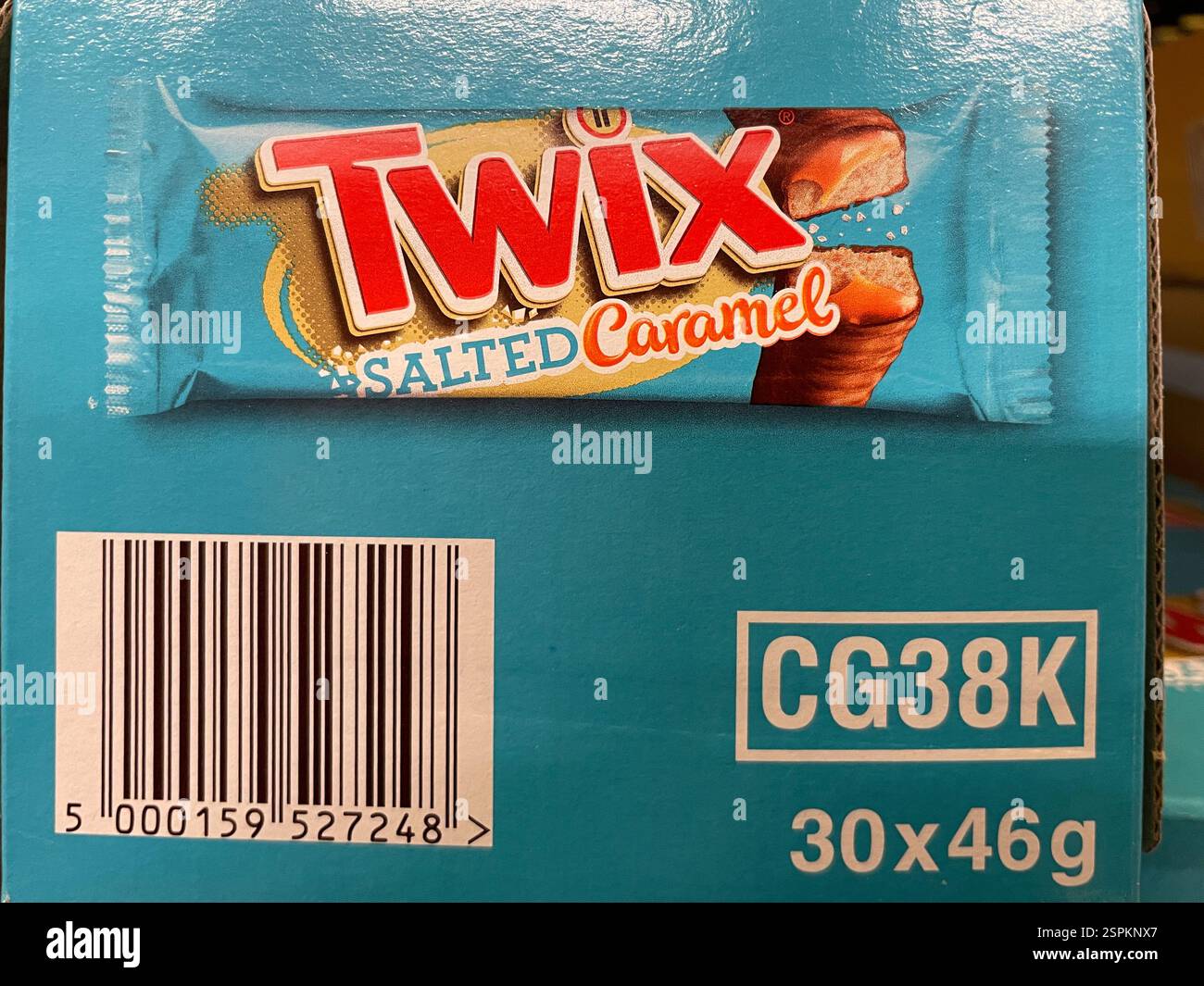 A teal-colored box displays a Twix Salted Caramel candy bar. The box ...