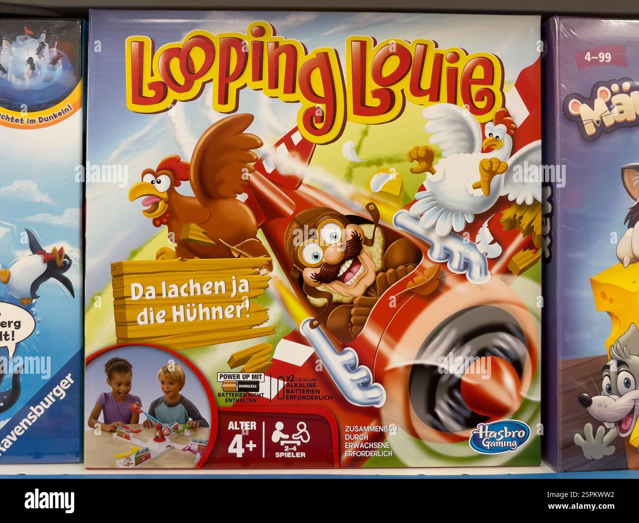 A German-language board game box features cartoon chickens, a pilot in ...