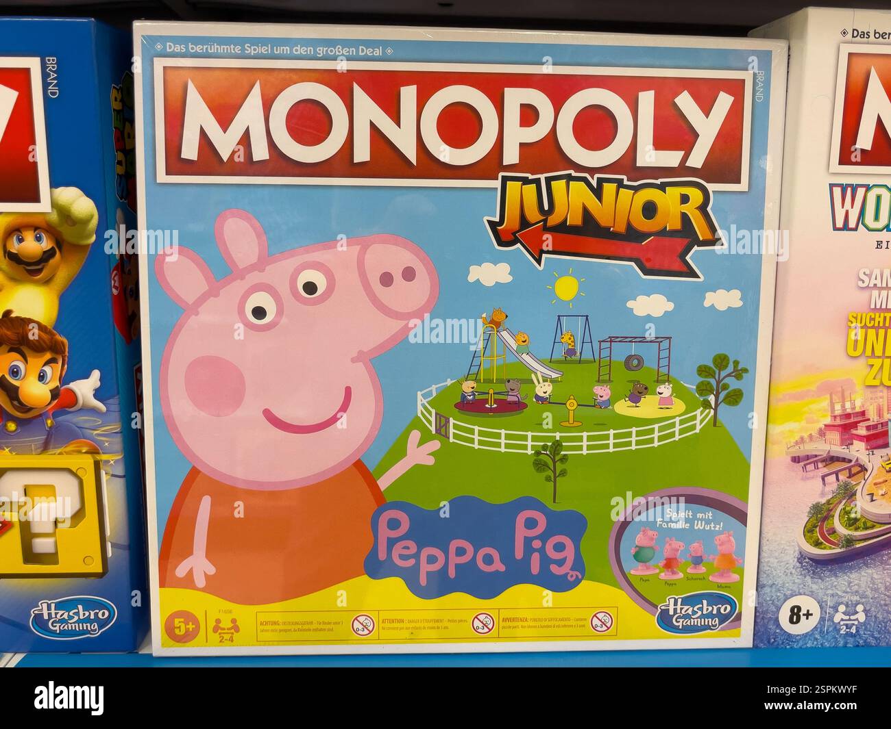 A Peppa Pig Monopoly Junior board game box is shown. The box features ...
