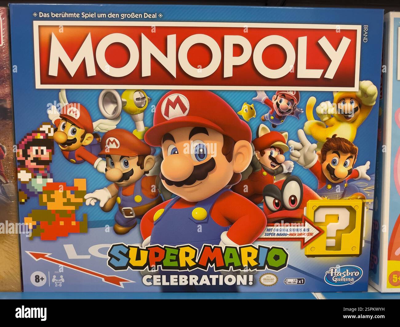 A Monopoly board game box featuring Super Mario characters. The box is ...