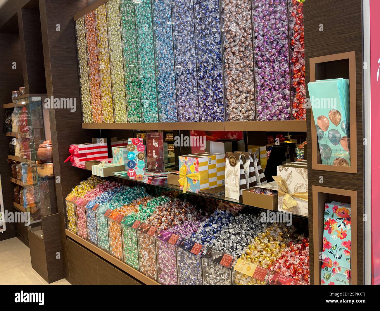 A retail display showcasing a wide variety of colorful chocolate ...