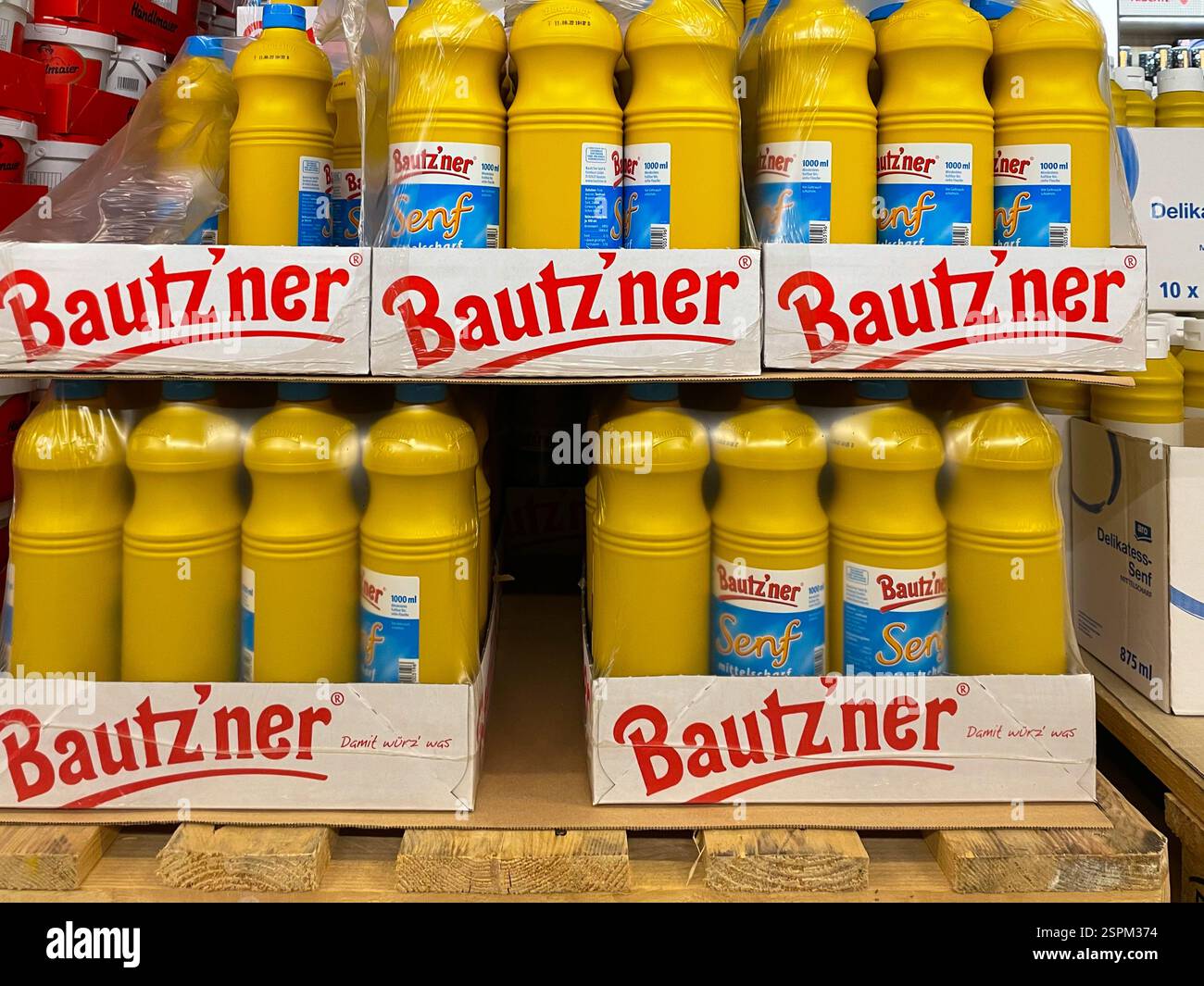 A pallet displays multiple boxes of Bautzner mustard. Each box contains ...