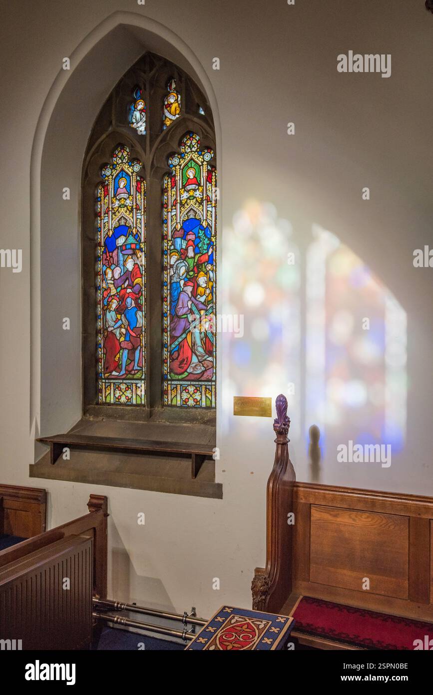 Light passed through the colours of a stained glass window create ...