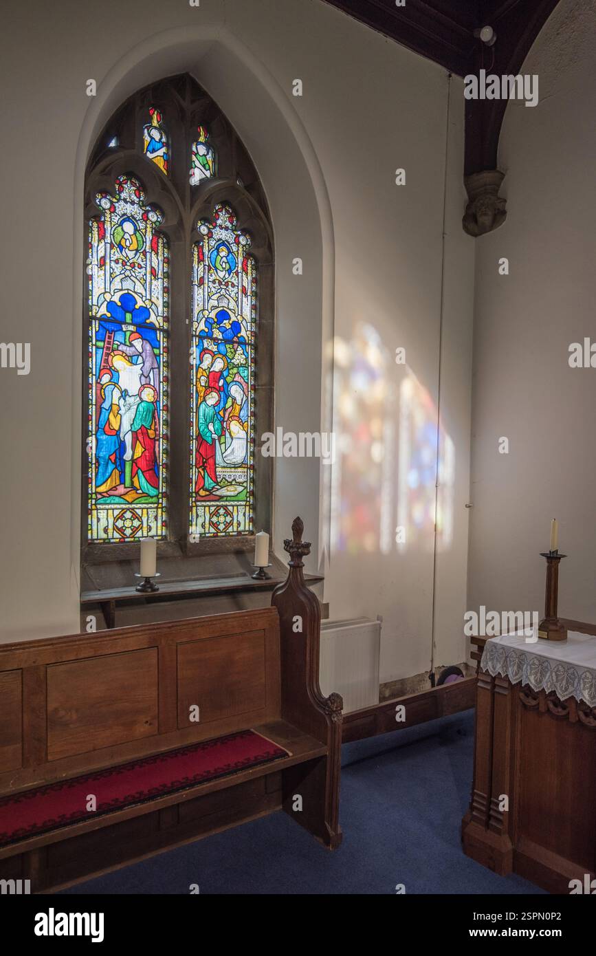 Light passed through the colours of a stained glass window create ...