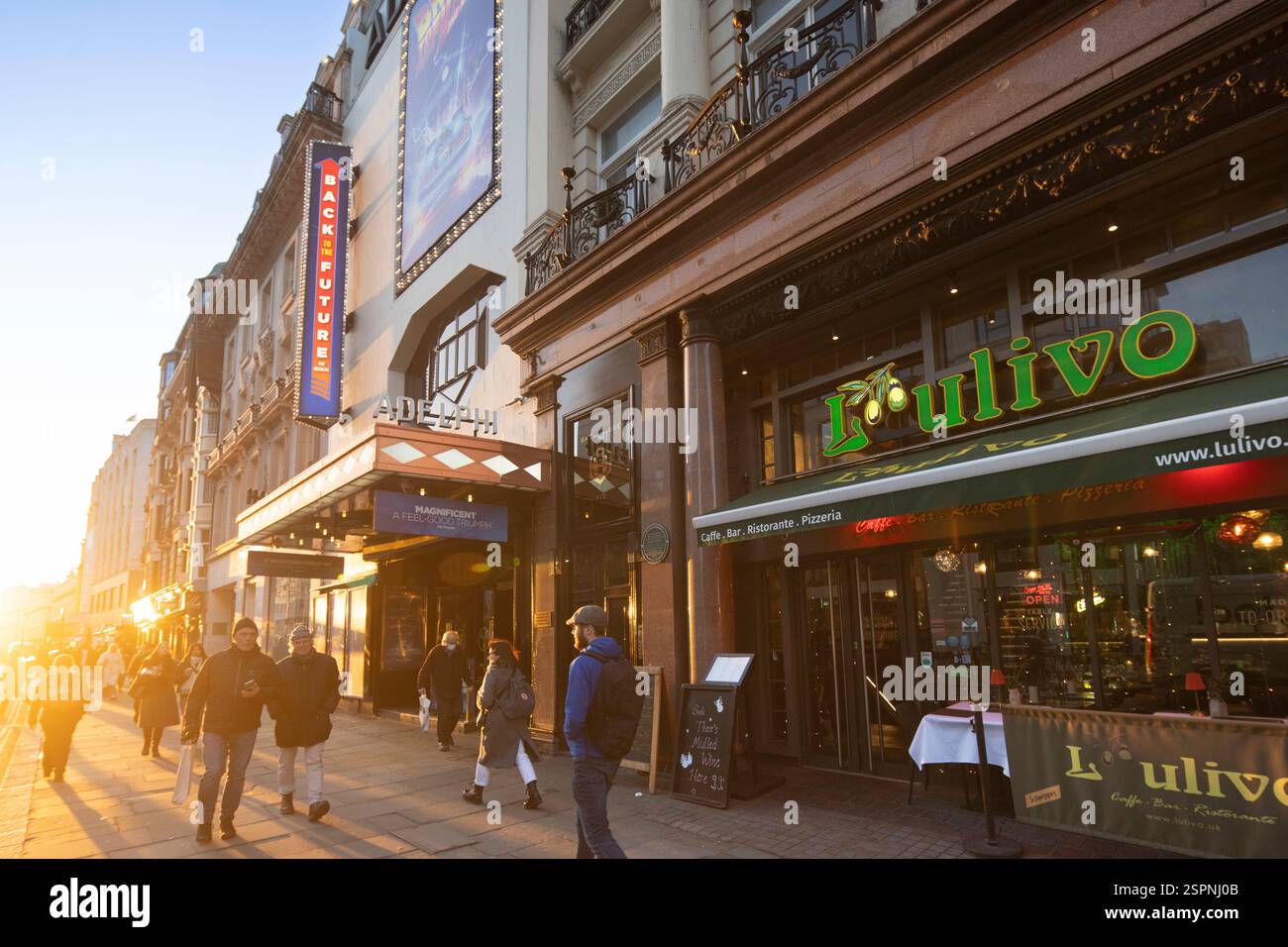 Pedestrians walk past the Adelphi Theatre and Lulivo restaurant in ...