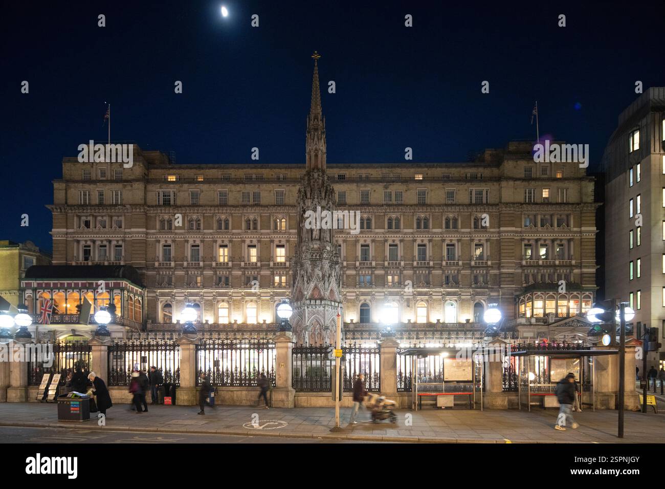 Night scene at London's Charing Cross Station. Pedestrians walk past ...