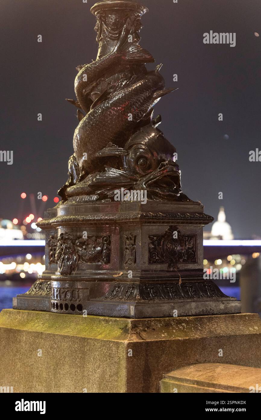 Ornamental lamp post base, fish-themed Stock Photo - Alamy