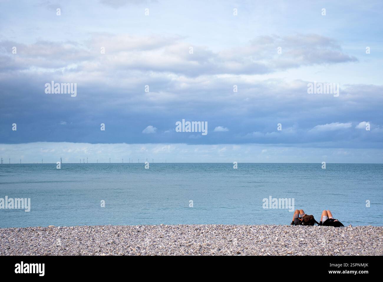Relaxing on the beach at Yport. Pebble beach with dramatic sky and wind ...