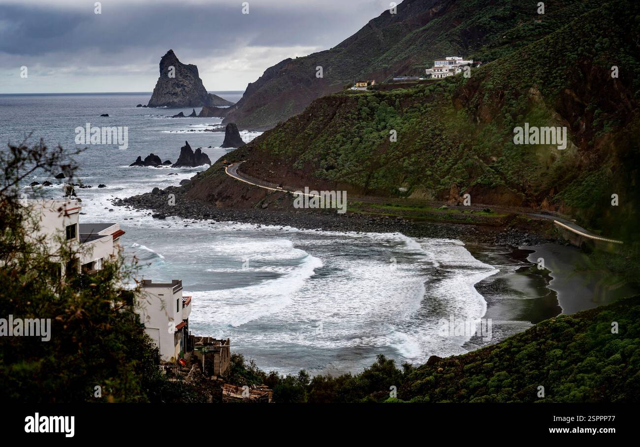 A scenic coastal view featuring rocky cliffs, a winding road, and ...