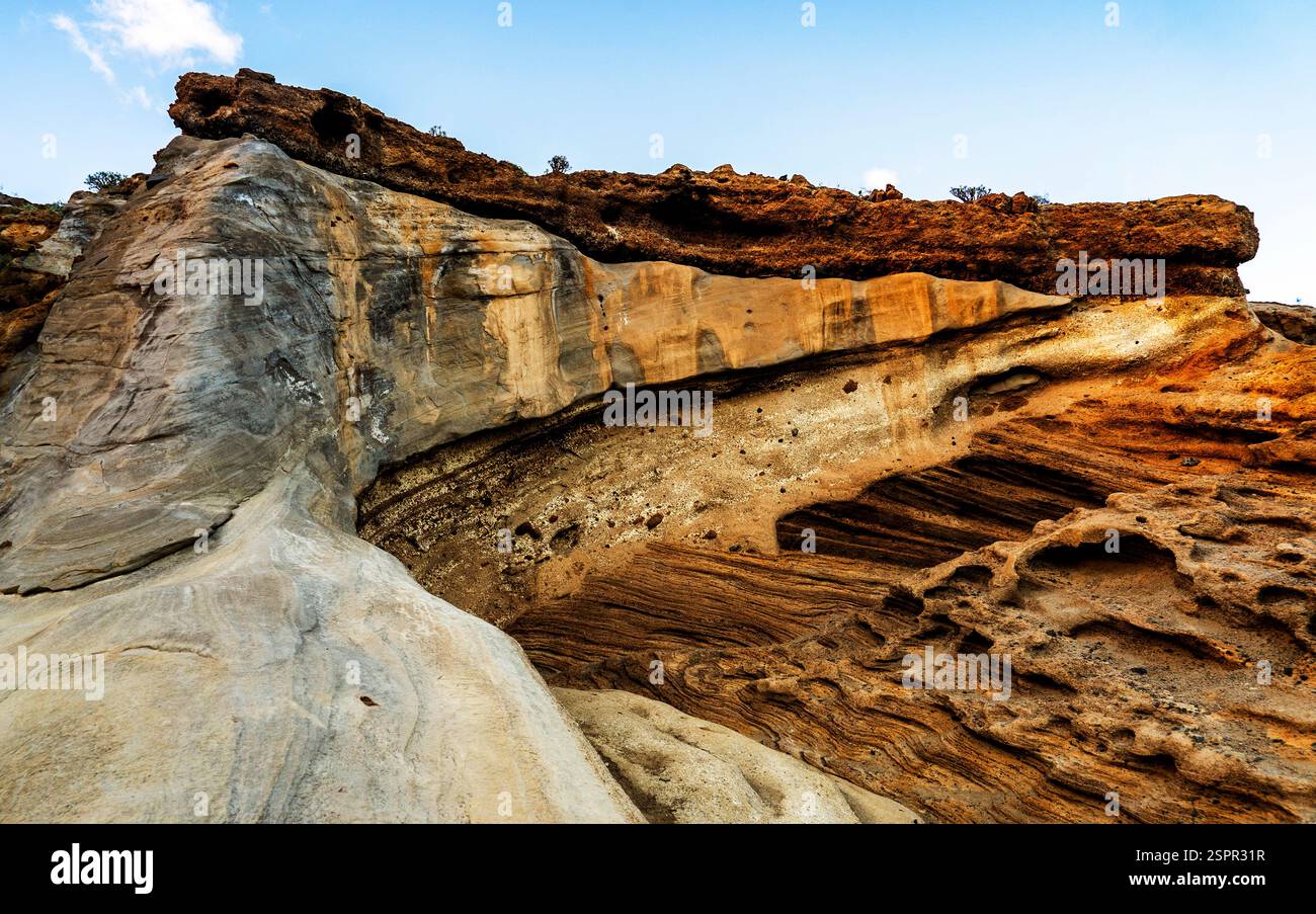 A dramatic rock formation showcasing layered textures and colors, with ...