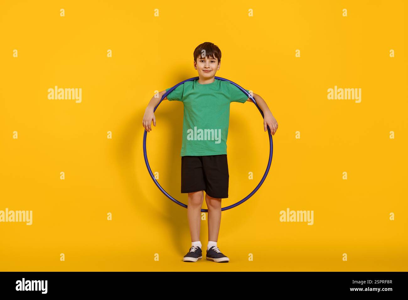 Boy with hula hoop on yellow background Stock Photo - Alamy