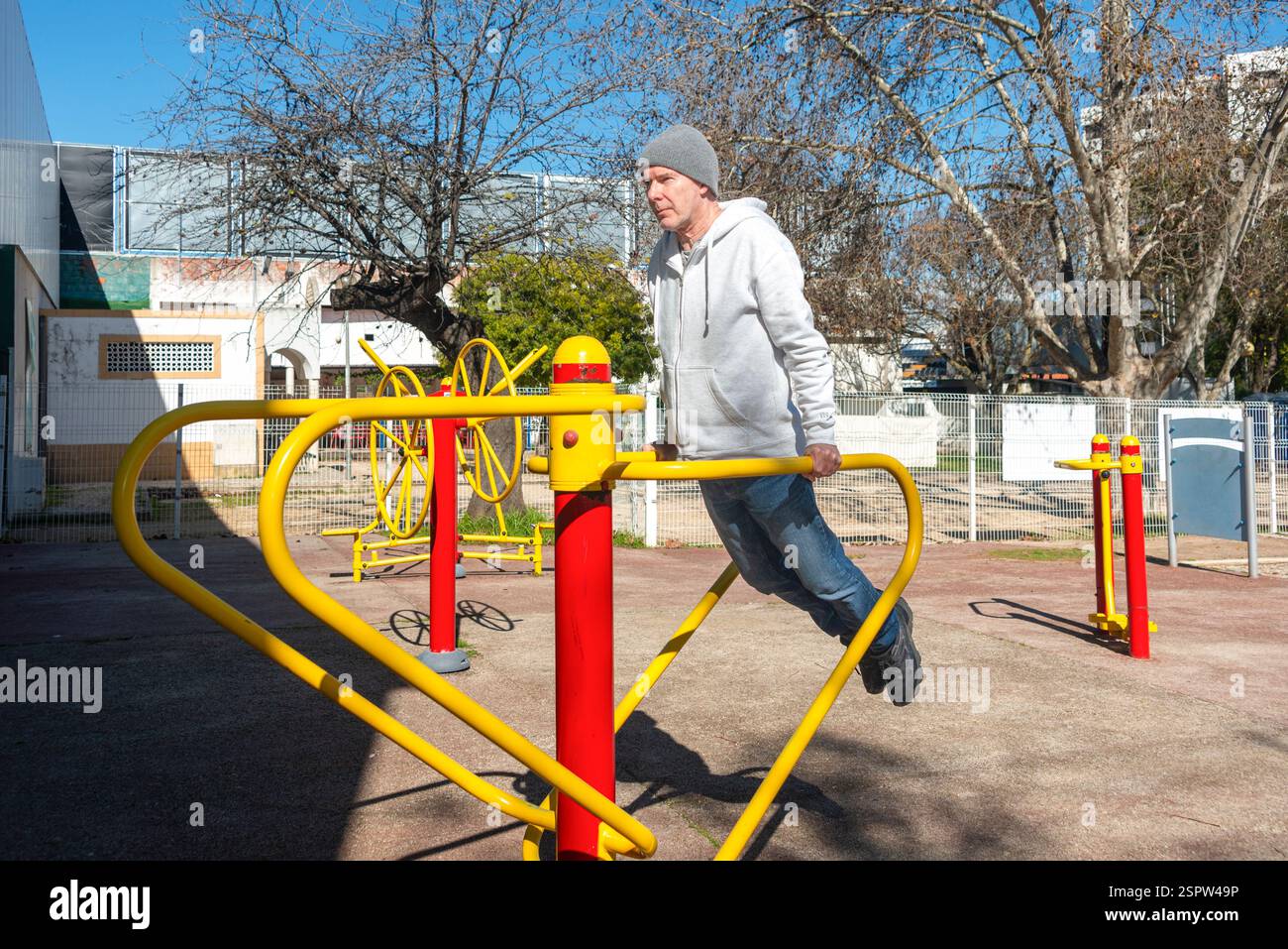 man using bars in outdoor gym, push up exercises Stock Photo - Alamy