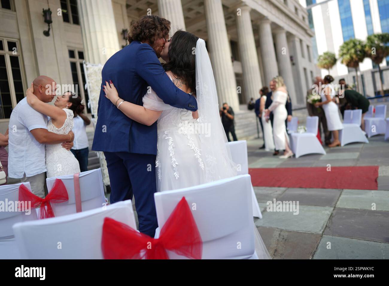 Vanessa Forare, center, and Alexander Del Toro kiss as newlywed couples ...