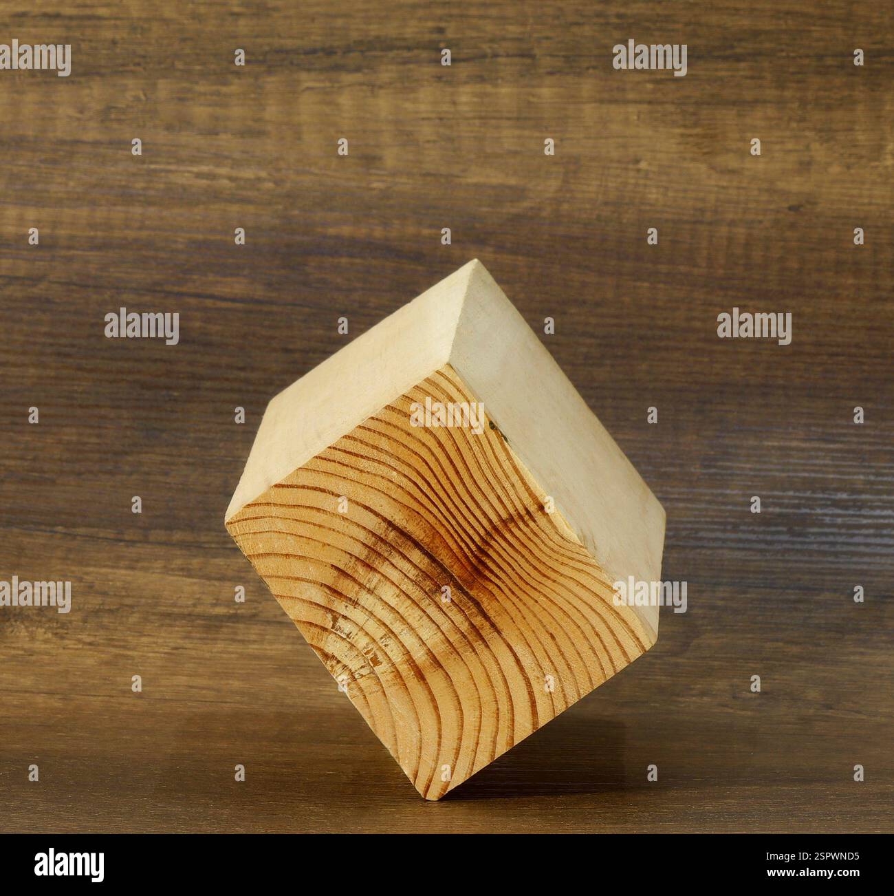 A wooden pine block stands on an edge in an unstable position Stock ...