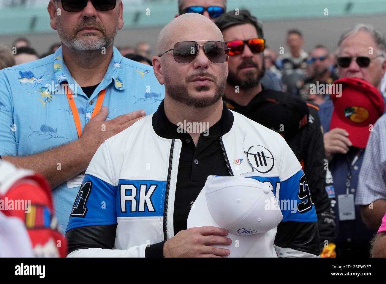 FILE - Singer, songwriter Pitbull stands during the singing of the ...