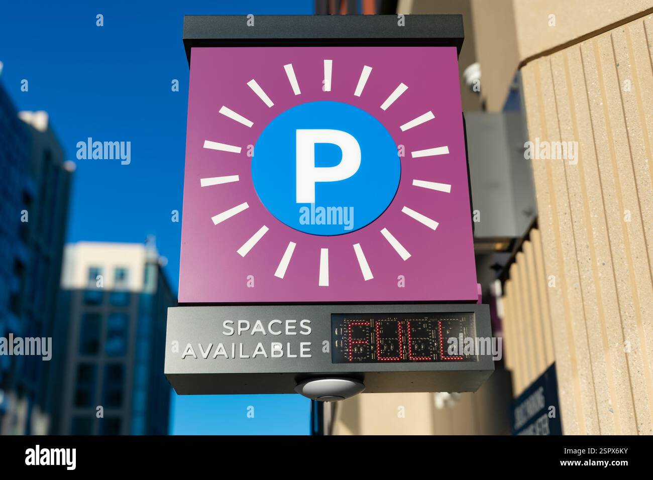 Digital parking signage with purple and blue color scheme against ...