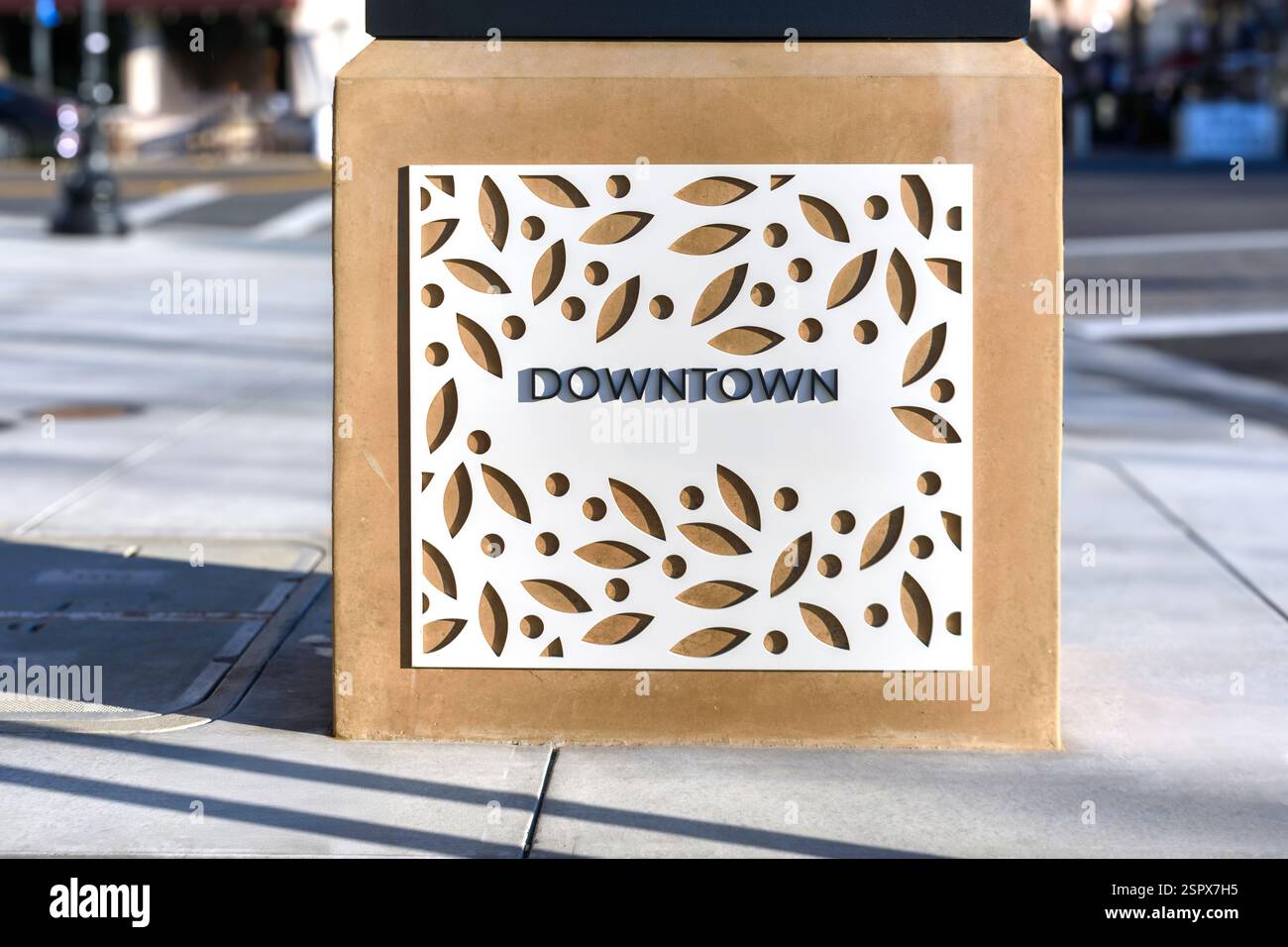 Modern Downtown sign featuring cut-out leaf designs, positioned on a ...