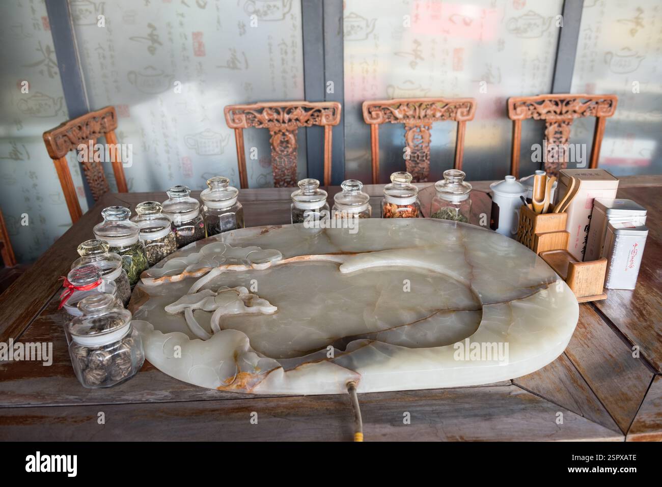 Collection of teas in jars around marble board for Traditional Chinese ...