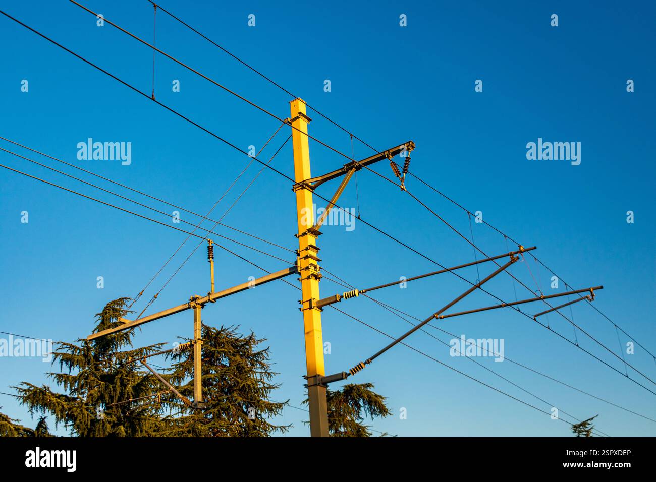 A railway catenary pole with overhead electrical wires Stock Photo - Alamy