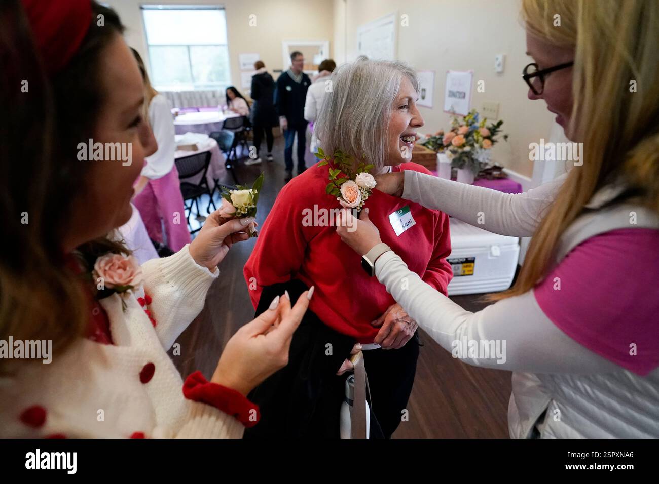 Jillian Myers, left, looks on as Ashley Manning, right, places a ...