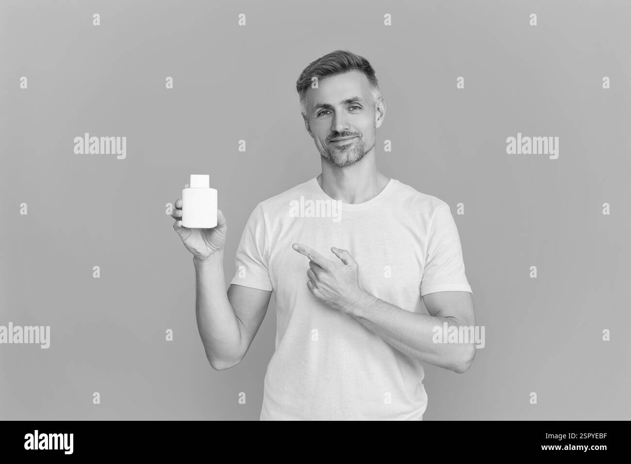 Mature man presenting multivitamins and vitamin daily supplement or ...