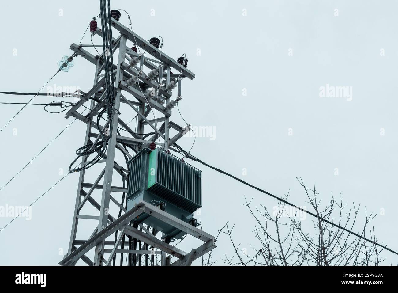 Smal transformer station on the top of power line pole. Frog view of a ...