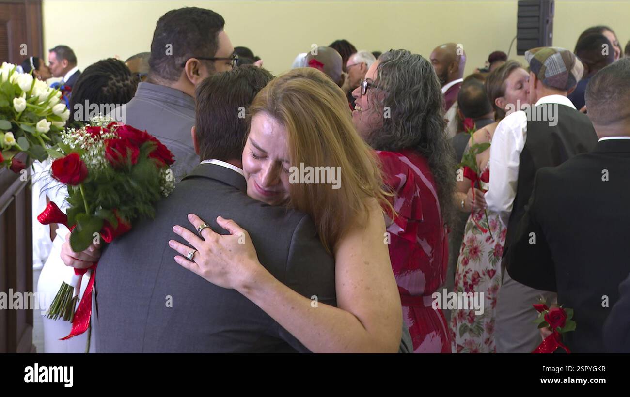 Couples embrace at a Valentine's Day group wedding ceremony in West ...