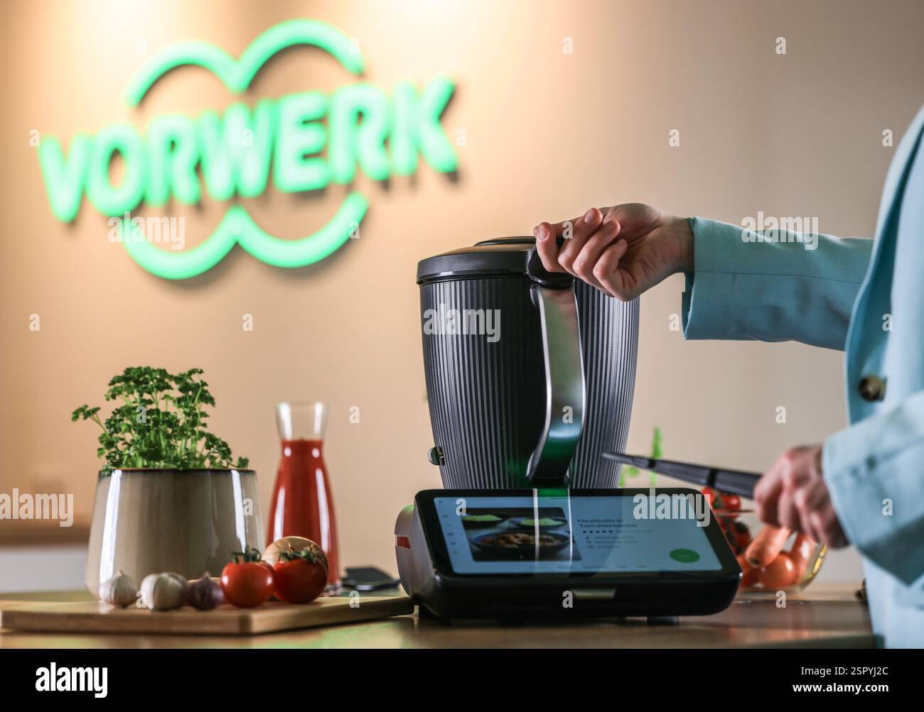 Cologne, Germany. 10th Feb, 2025. A woman operates the new Thermomix ...
