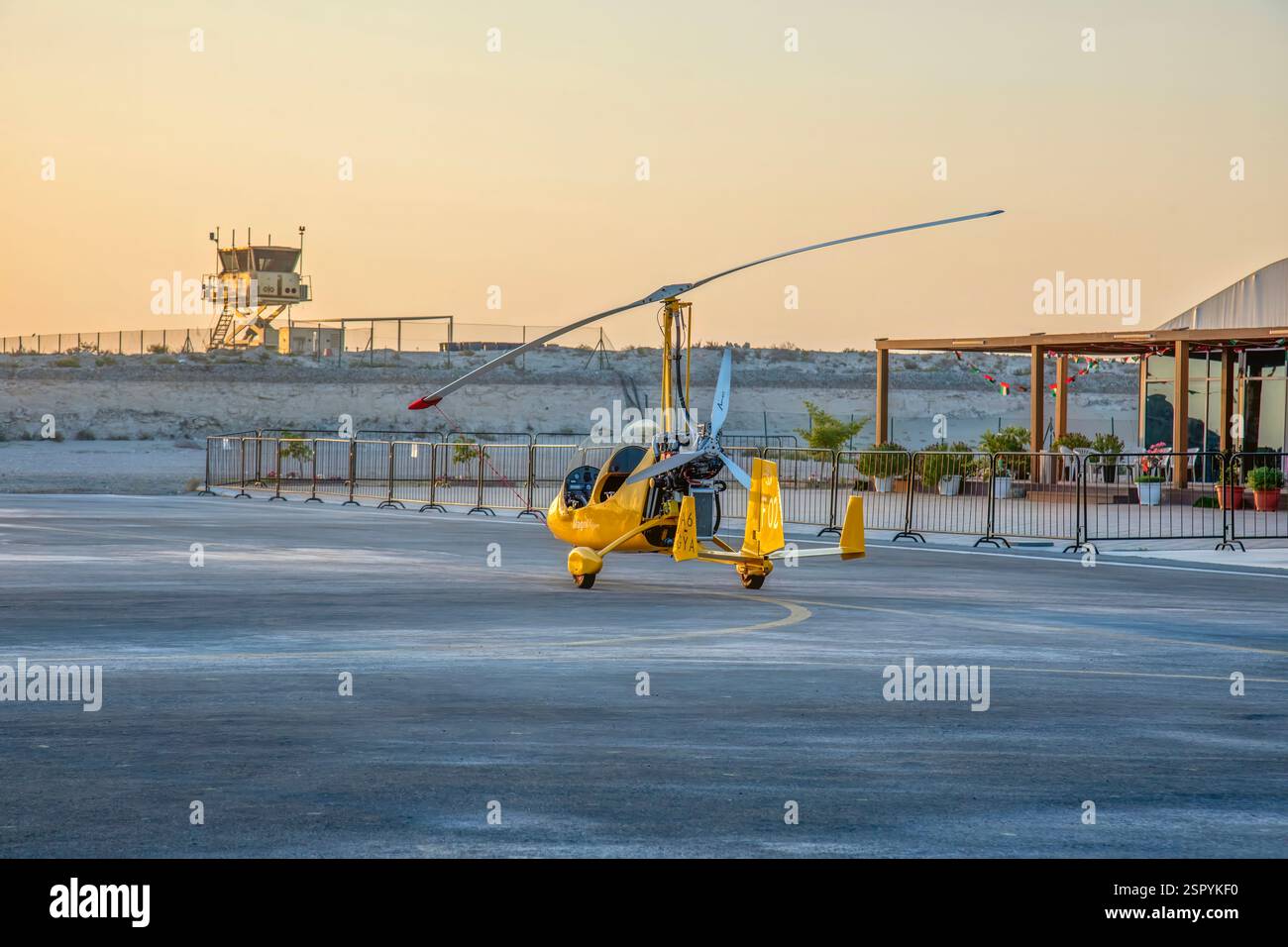 Small light helicopter Auto Gyro in yellow color on the ground. Super ...