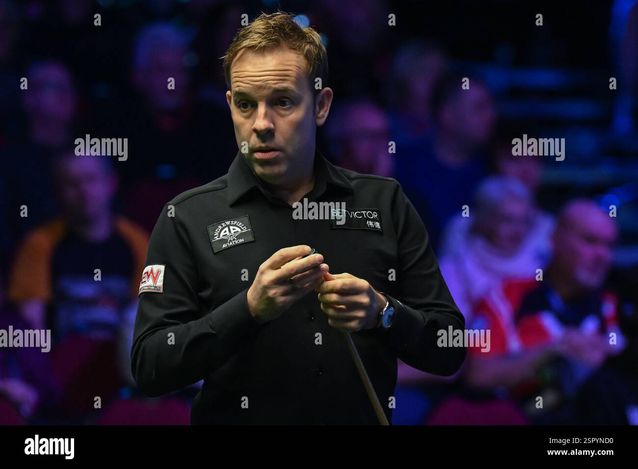 Ali Carter chalks his cue during his quarter finals match against Joe O ...