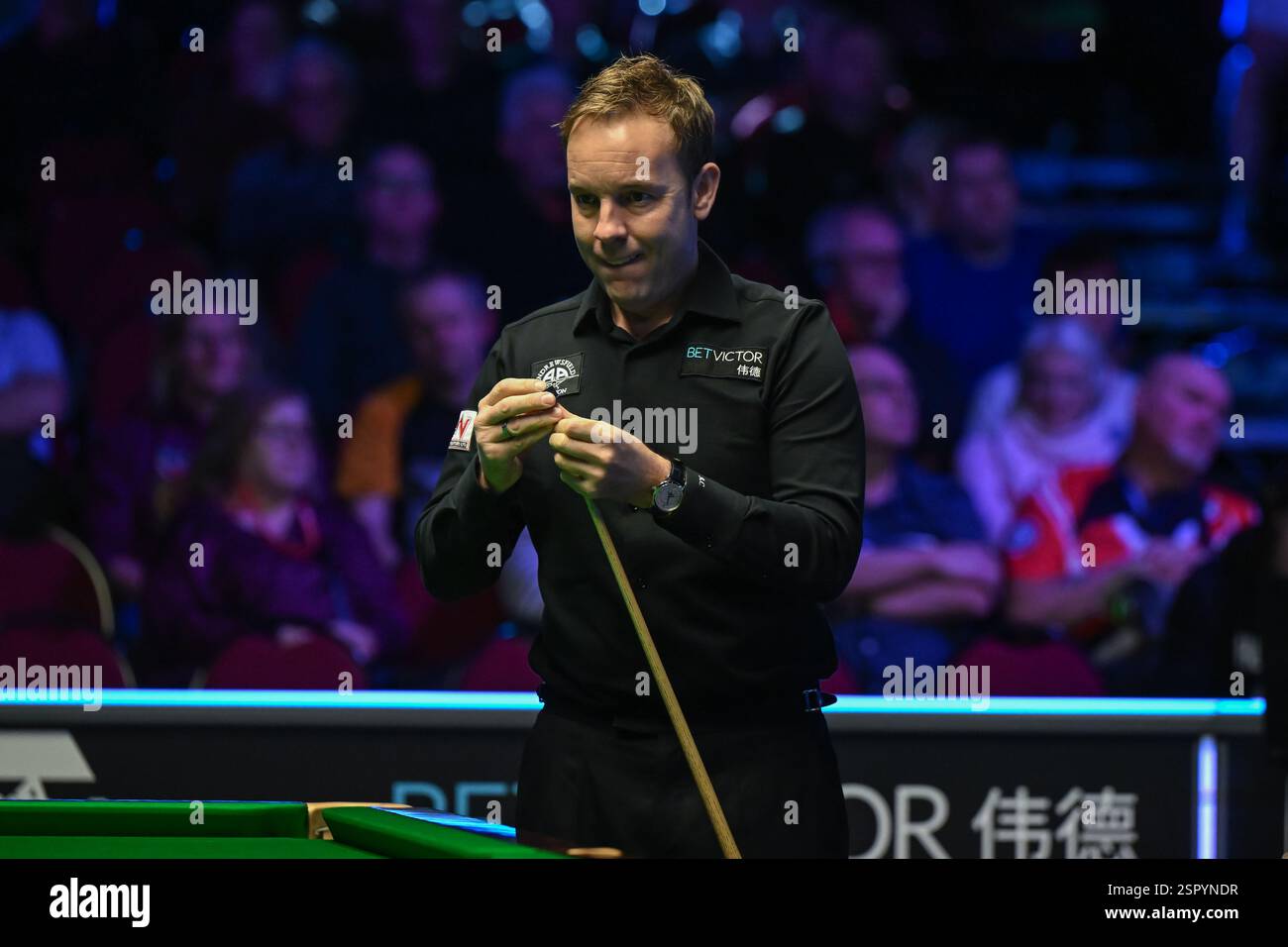 Ali Carter chalks his cue during his quarter finals match against Joe O ...