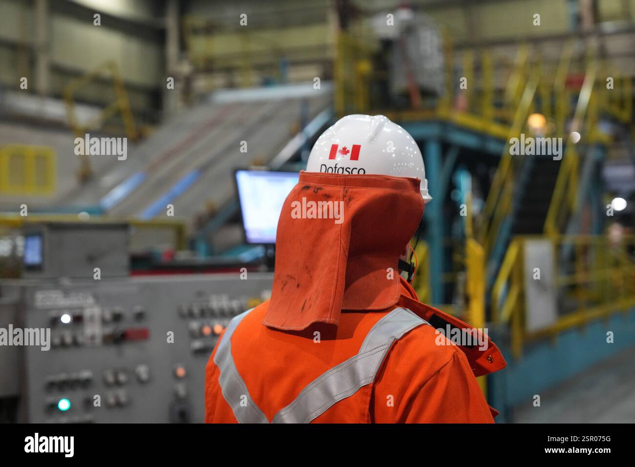 A steelworker walks through the ArcelorMittal Dofasco Steel Plant in ...