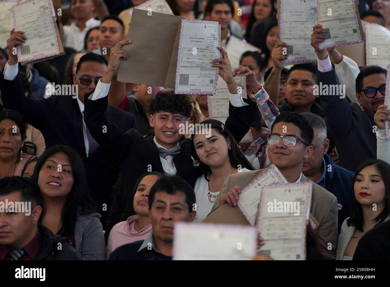 Newlyweds Roberto Carlos Martinez, center, holds up his marriage ...