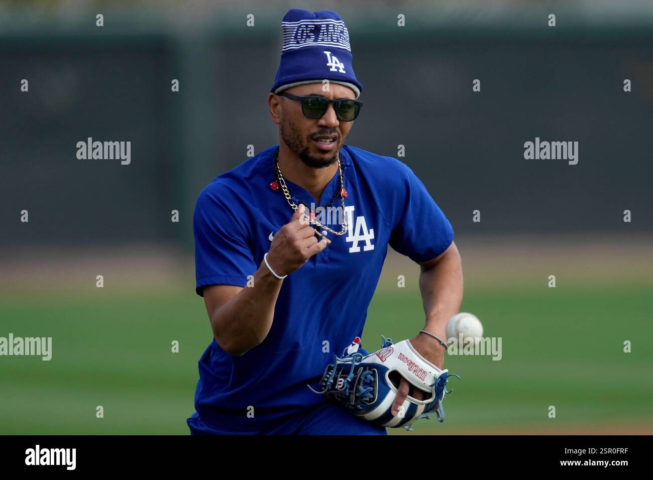 Los Angeles Dodgers' Mookie Betts runs drills during a baseball spring ...