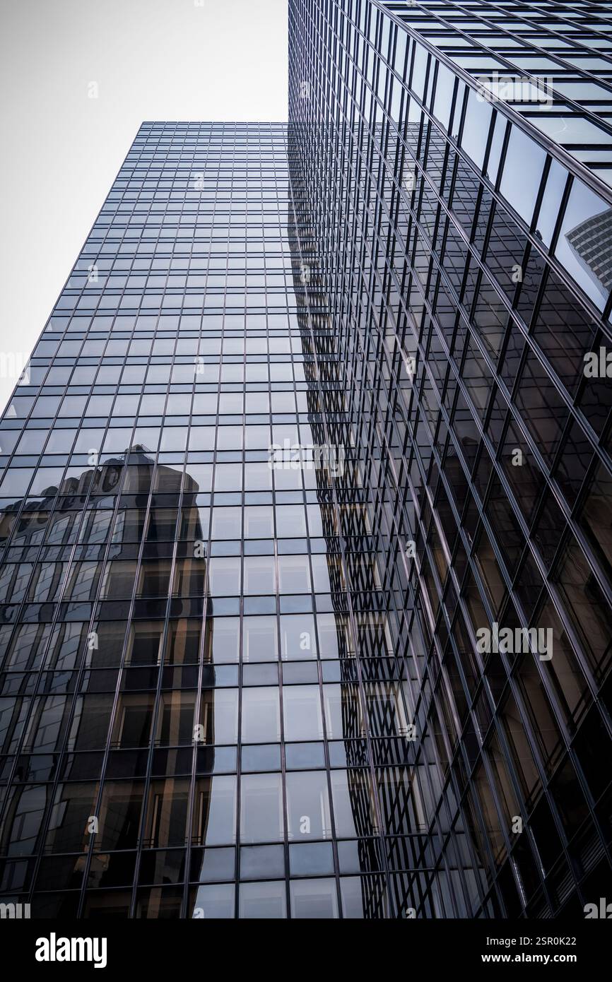 Glass towers reflect the urban skyline beneath a clear blue sky Stock ...