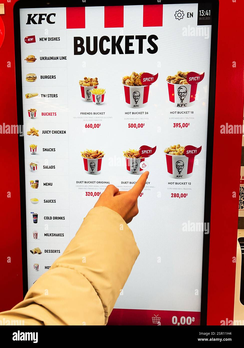 Lviv, Ukraine - February 13, 2025: Customer choosing KFC items from a ...